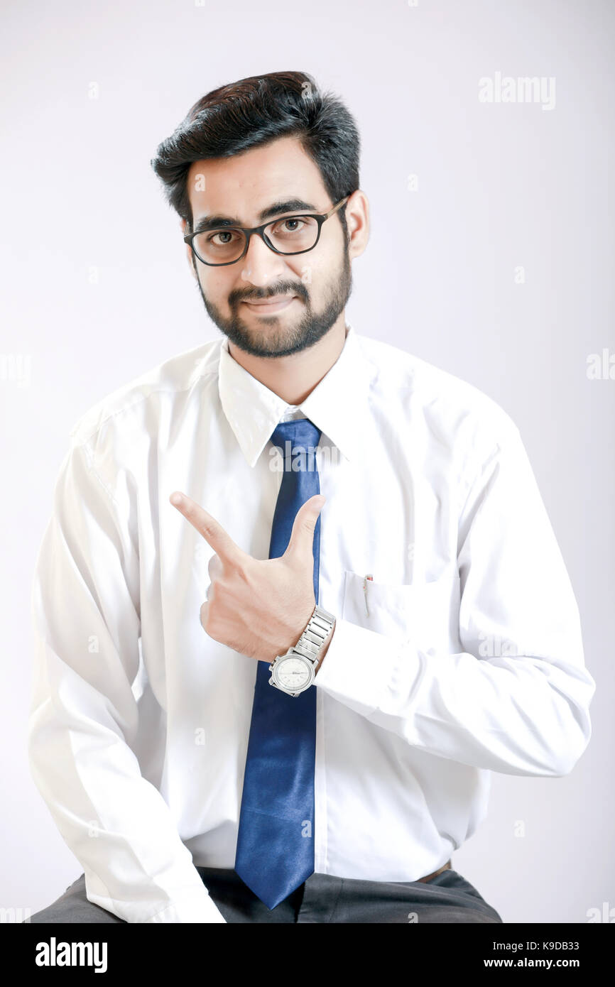 Indian young man showing direction with hand Stock Photo - Alamy