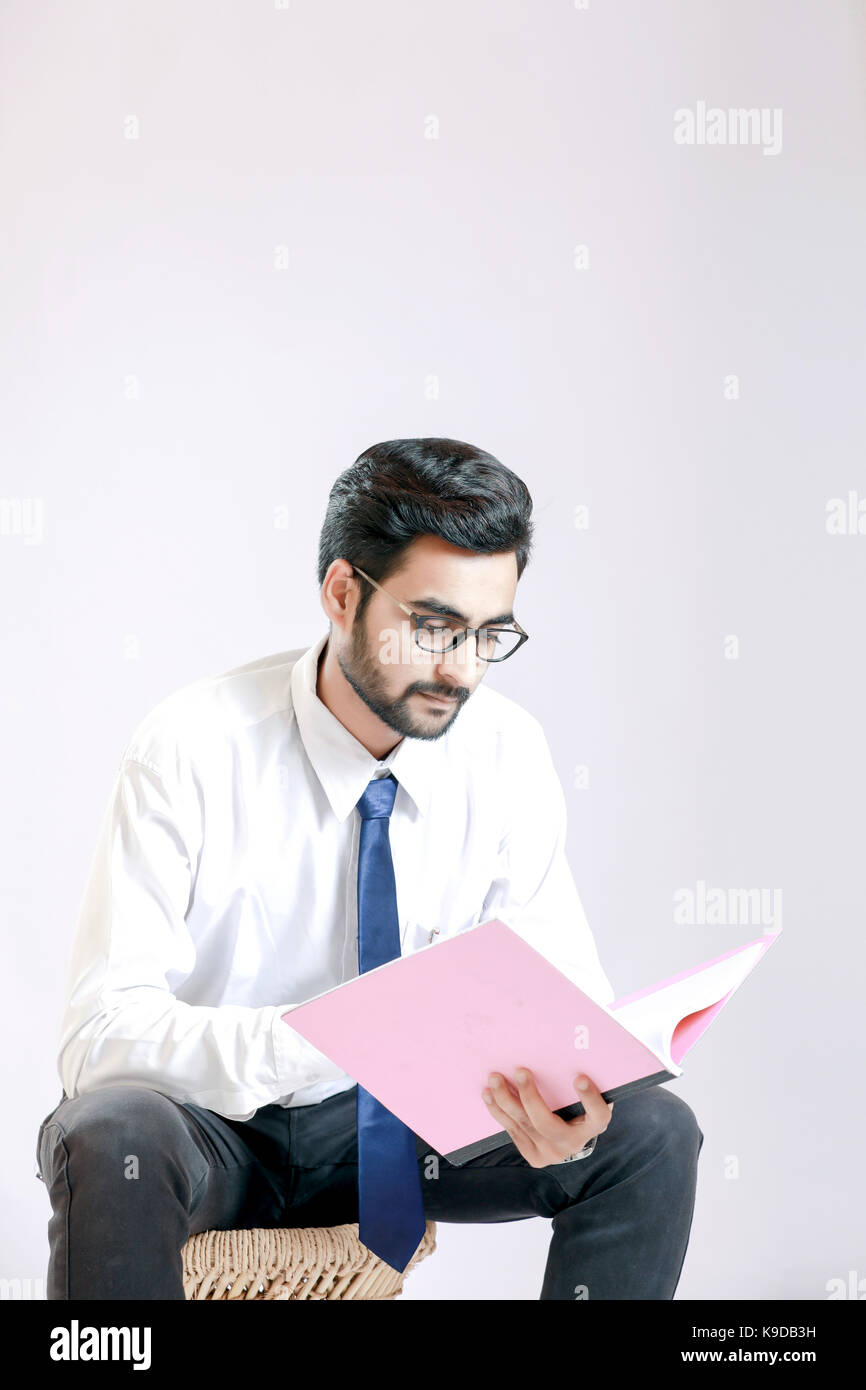 Young Indian man reading book Stock Photo - Alamy