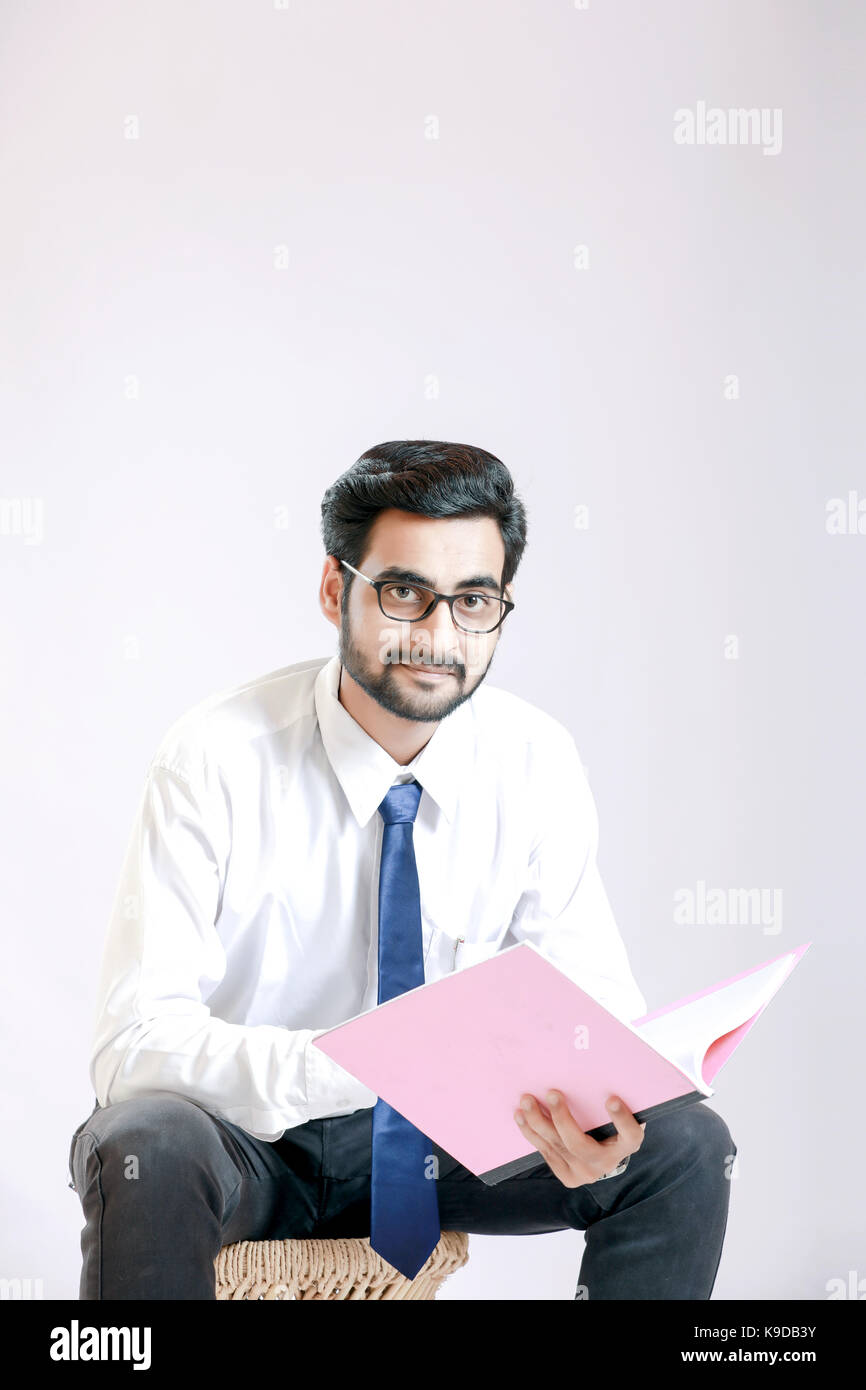 Young Indian man reading book Stock Photo - Alamy