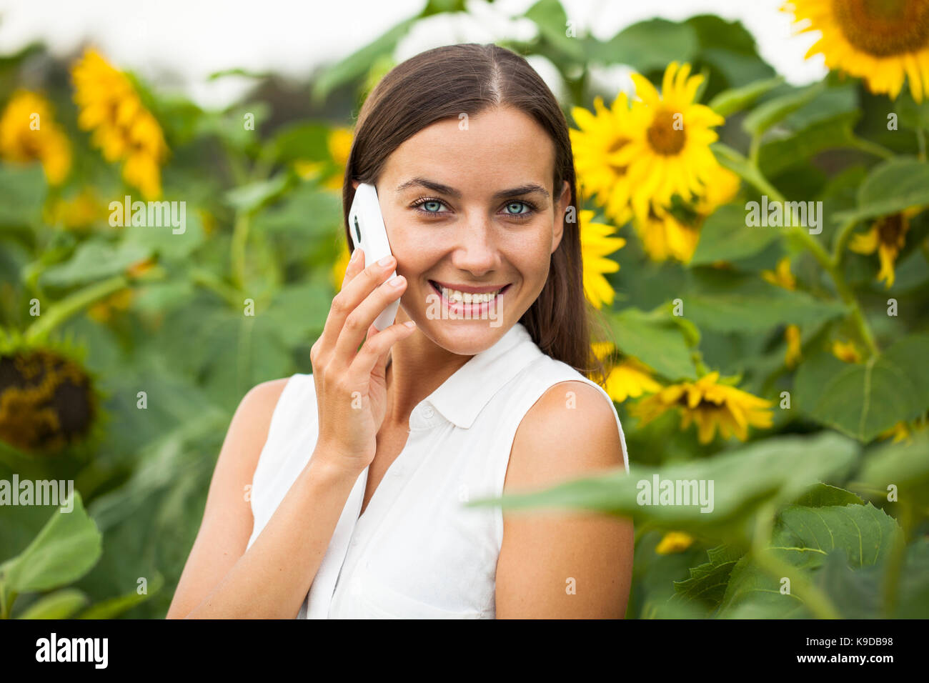 Happy young woman calling by phone. Close up portrait of beautiful ...