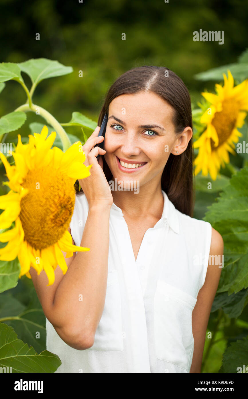 Happy young woman calling by phone. Close up portrait of beautiful ...