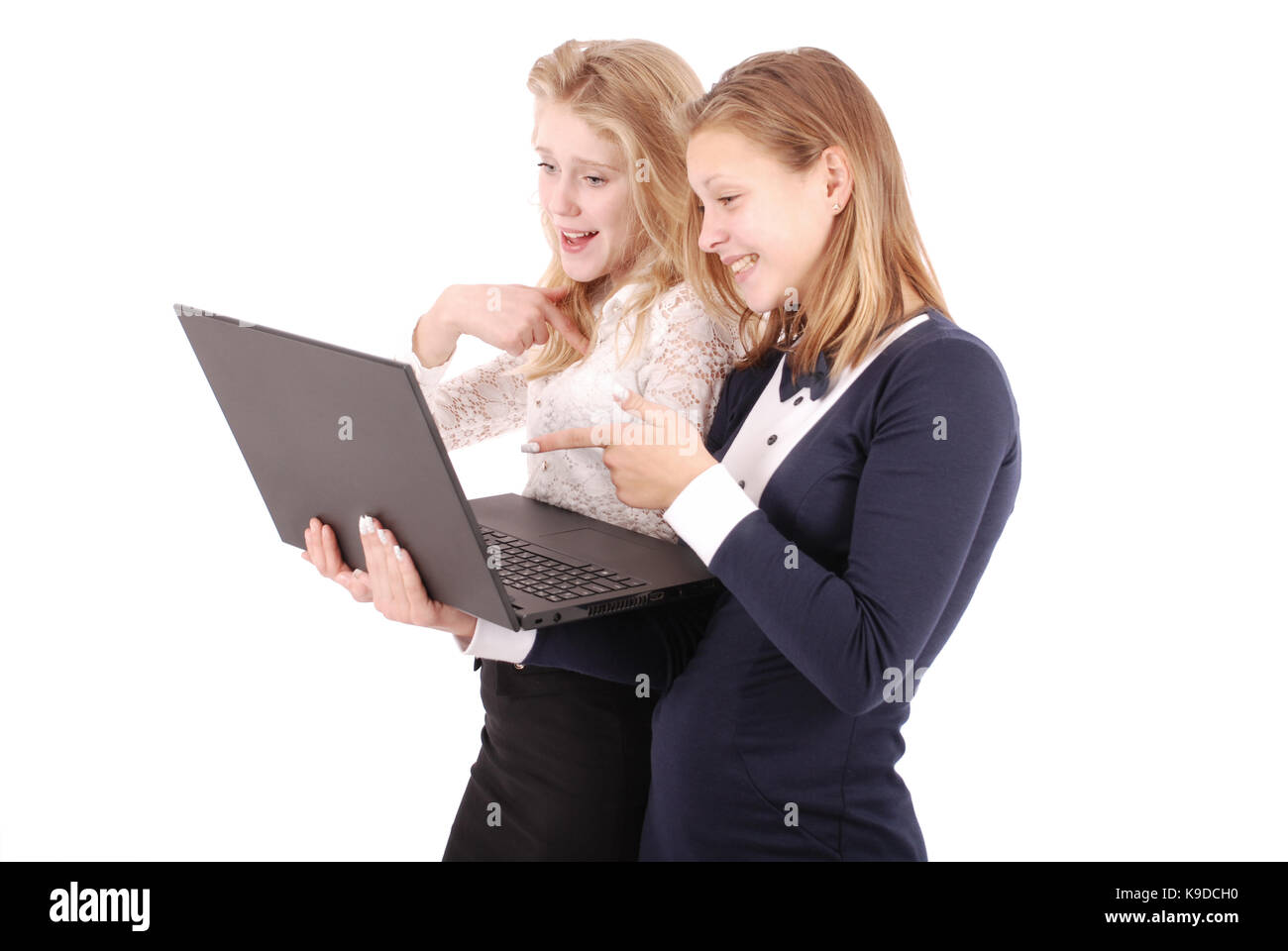 Two shocked girls using laptop isolated on a white background Stock ...