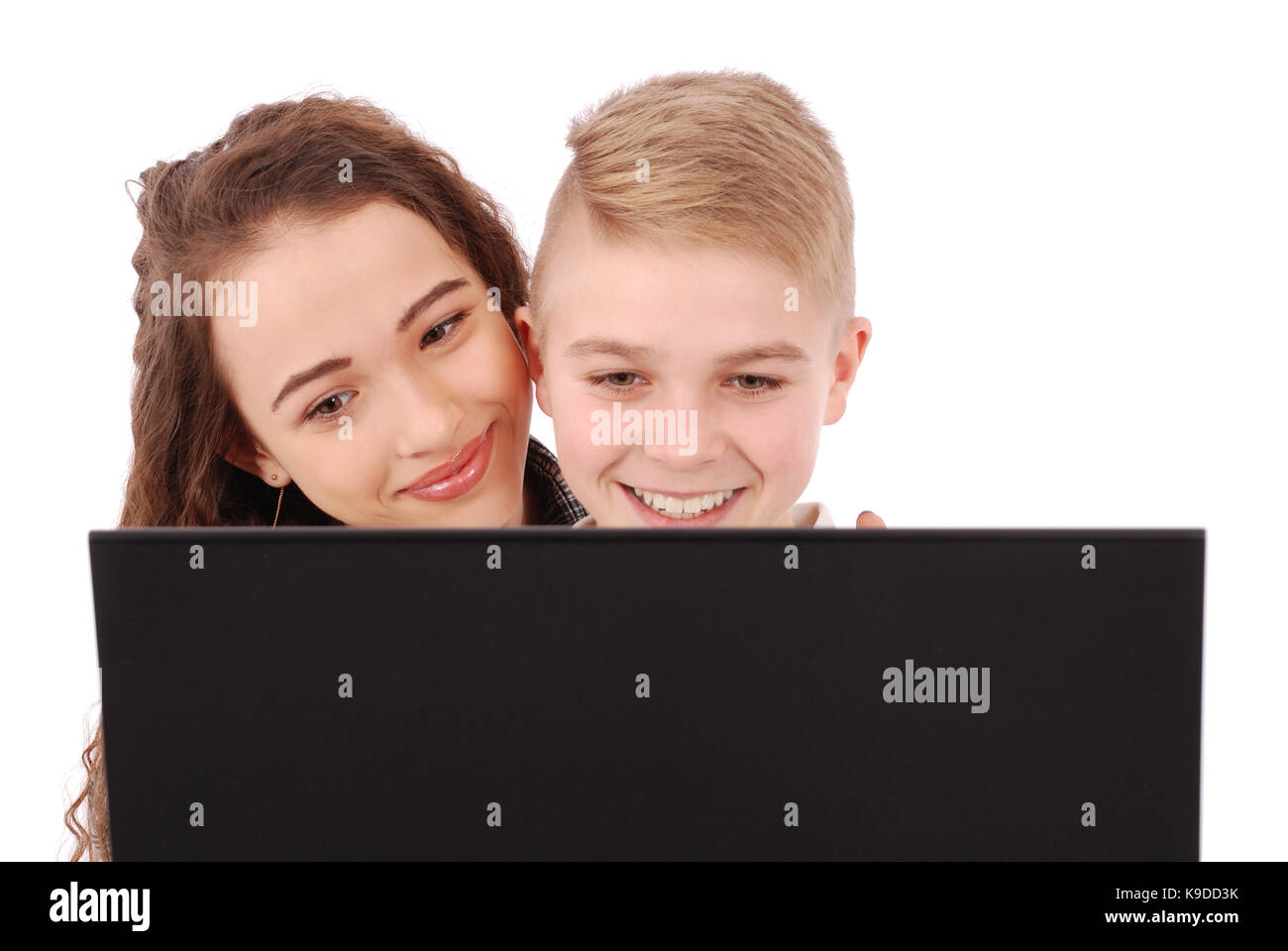 Boy and girl using a laptop isolated on white background Stock Photo ...