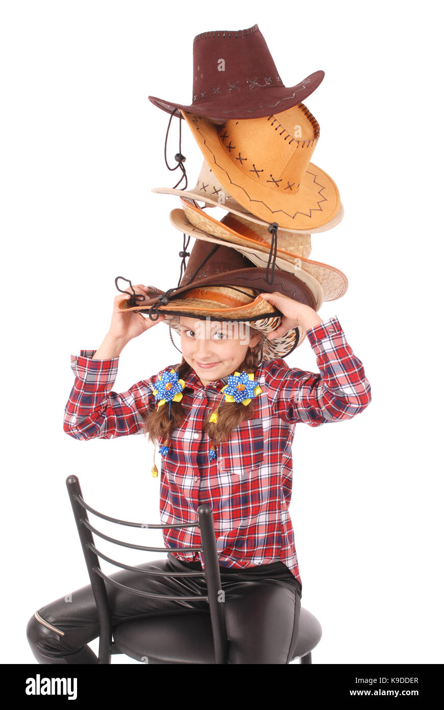 Portrait of adorable smiling little girl sitting on a chair with her ...