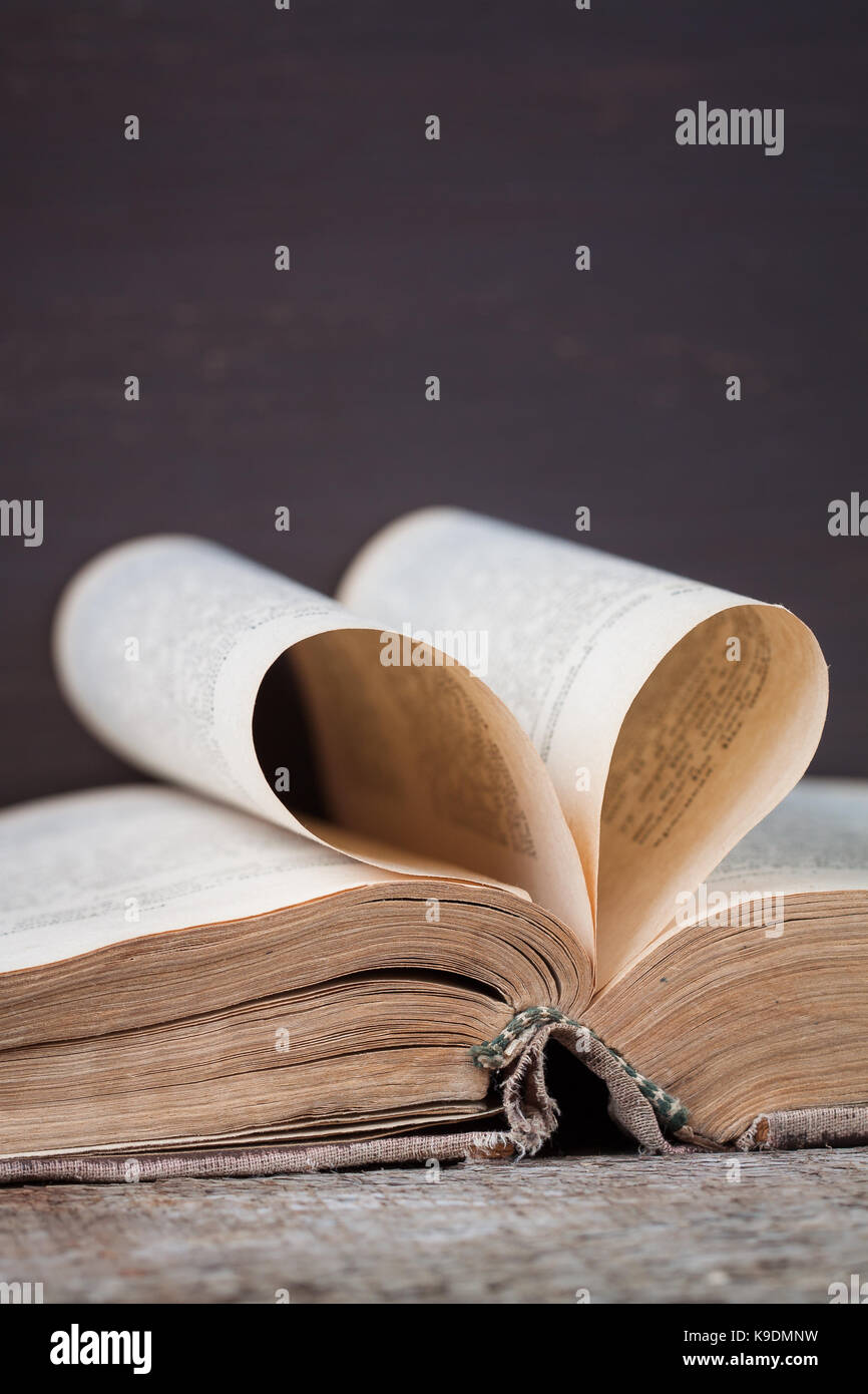 An old book with heart-shaped pages, vertical view Stock Photo - Alamy