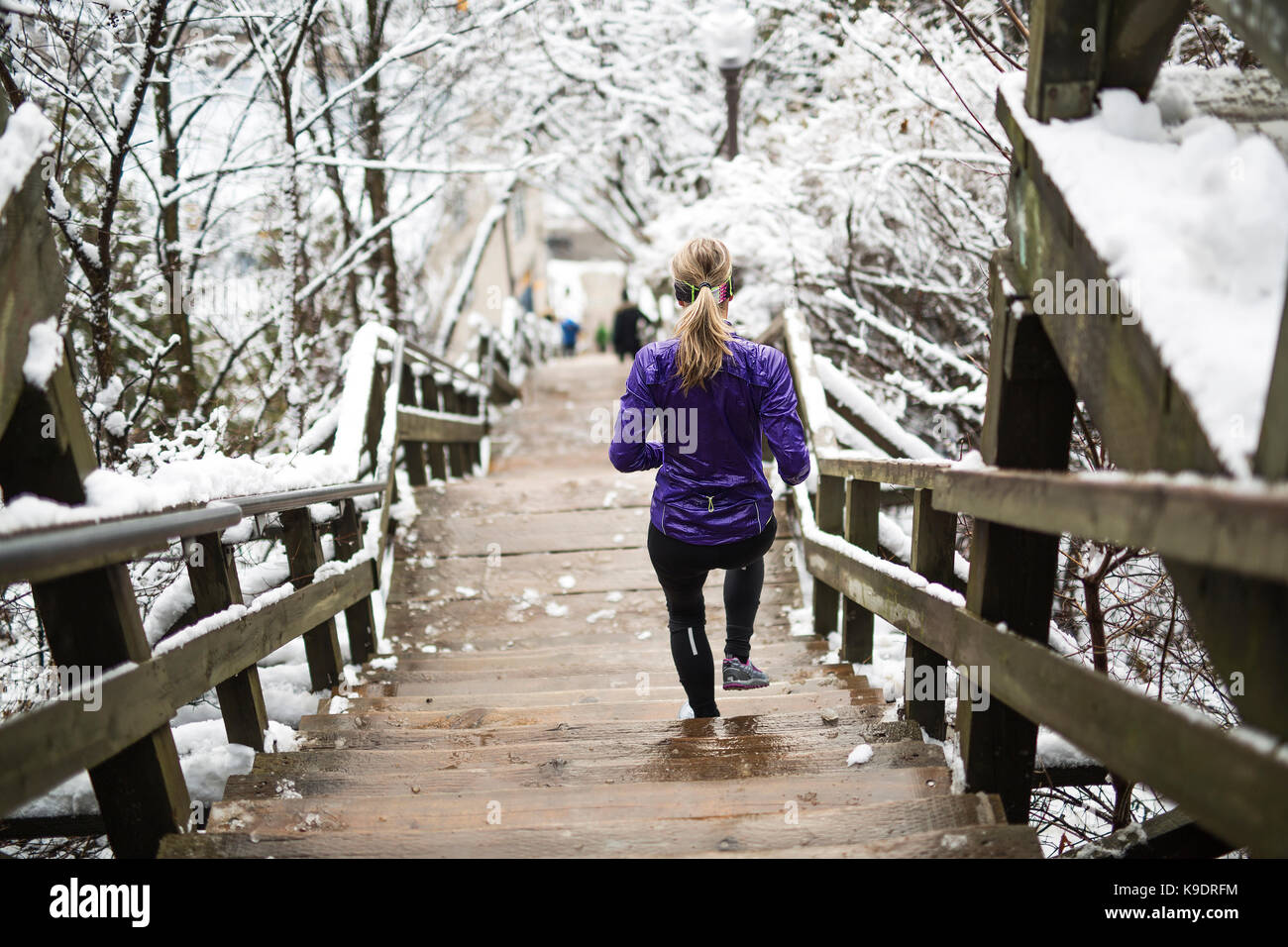 A Fitness running woman in winter season Stock Photo - Alamy