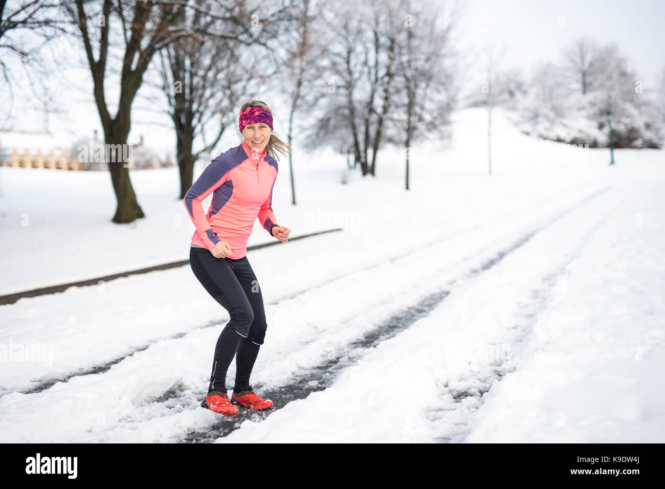 A Fitness running woman in winter season Stock Photo - Alamy