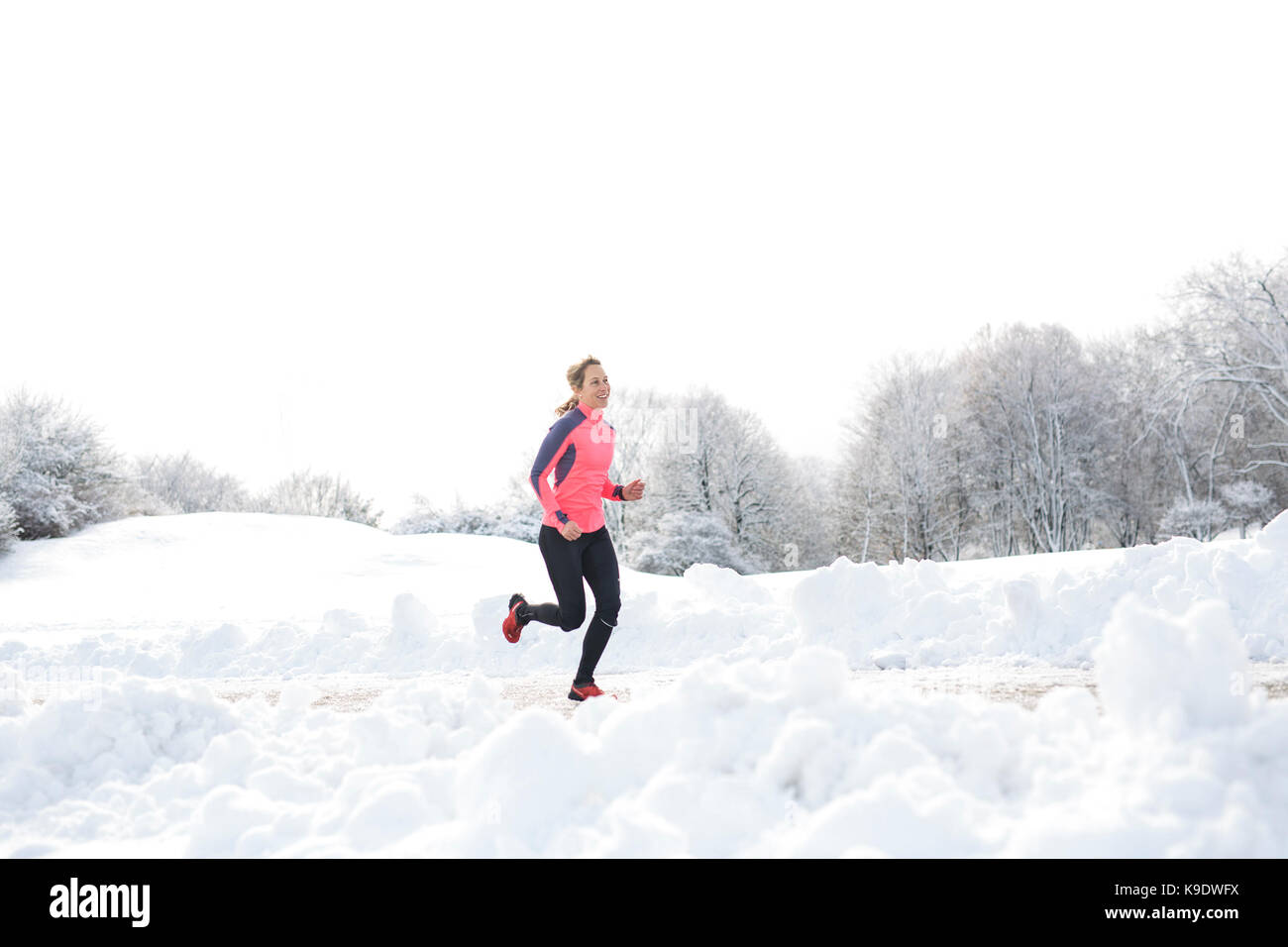 A Fitness running woman in winter season Stock Photo - Alamy