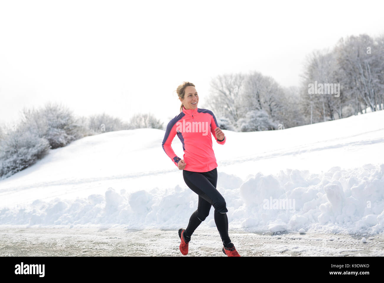 A Fitness running woman in winter season Stock Photo - Alamy