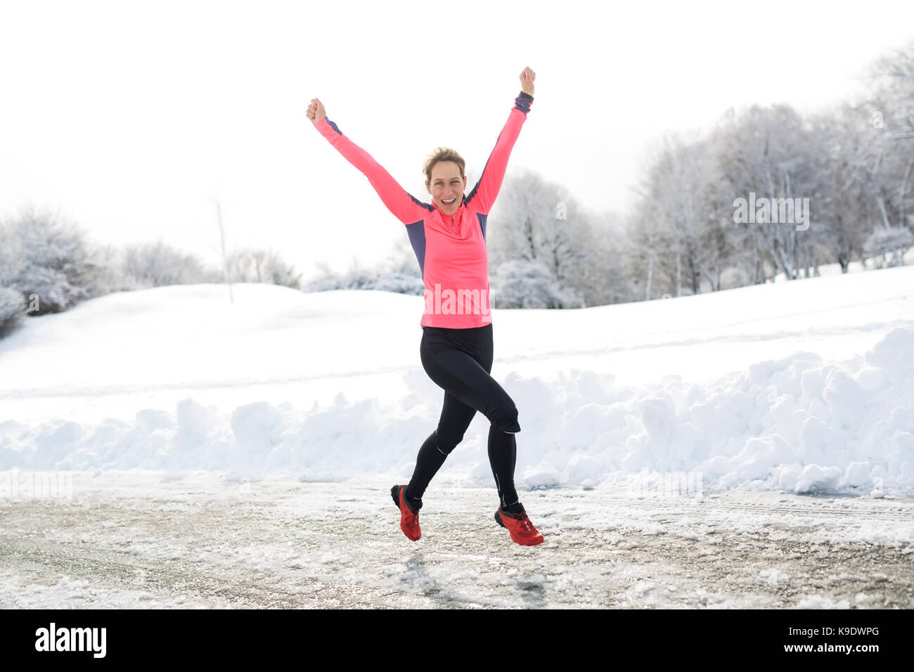 A Fitness running woman in winter season Stock Photo - Alamy