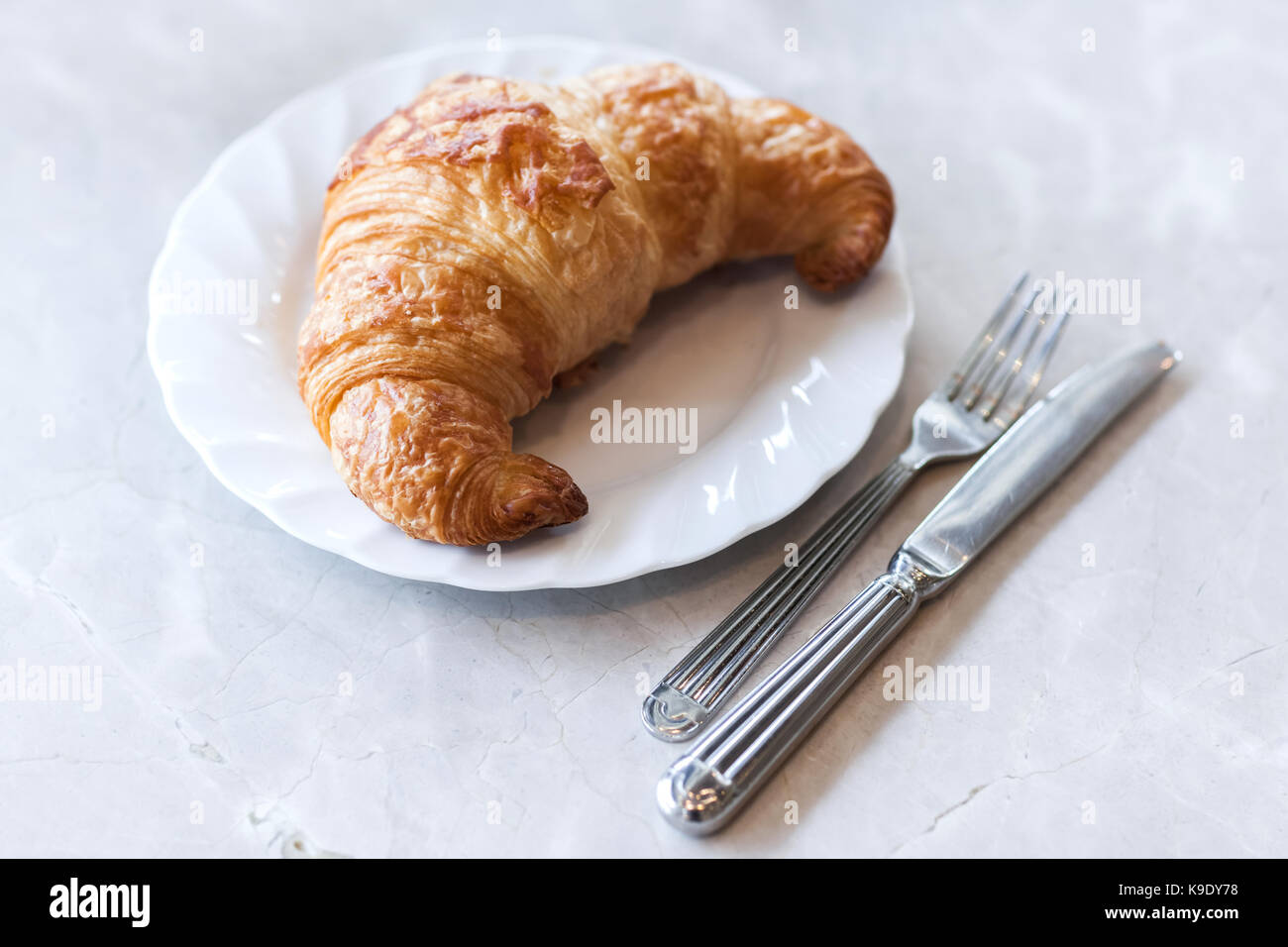 Delicious classic croissant on vintage white plate, isolated on white ...