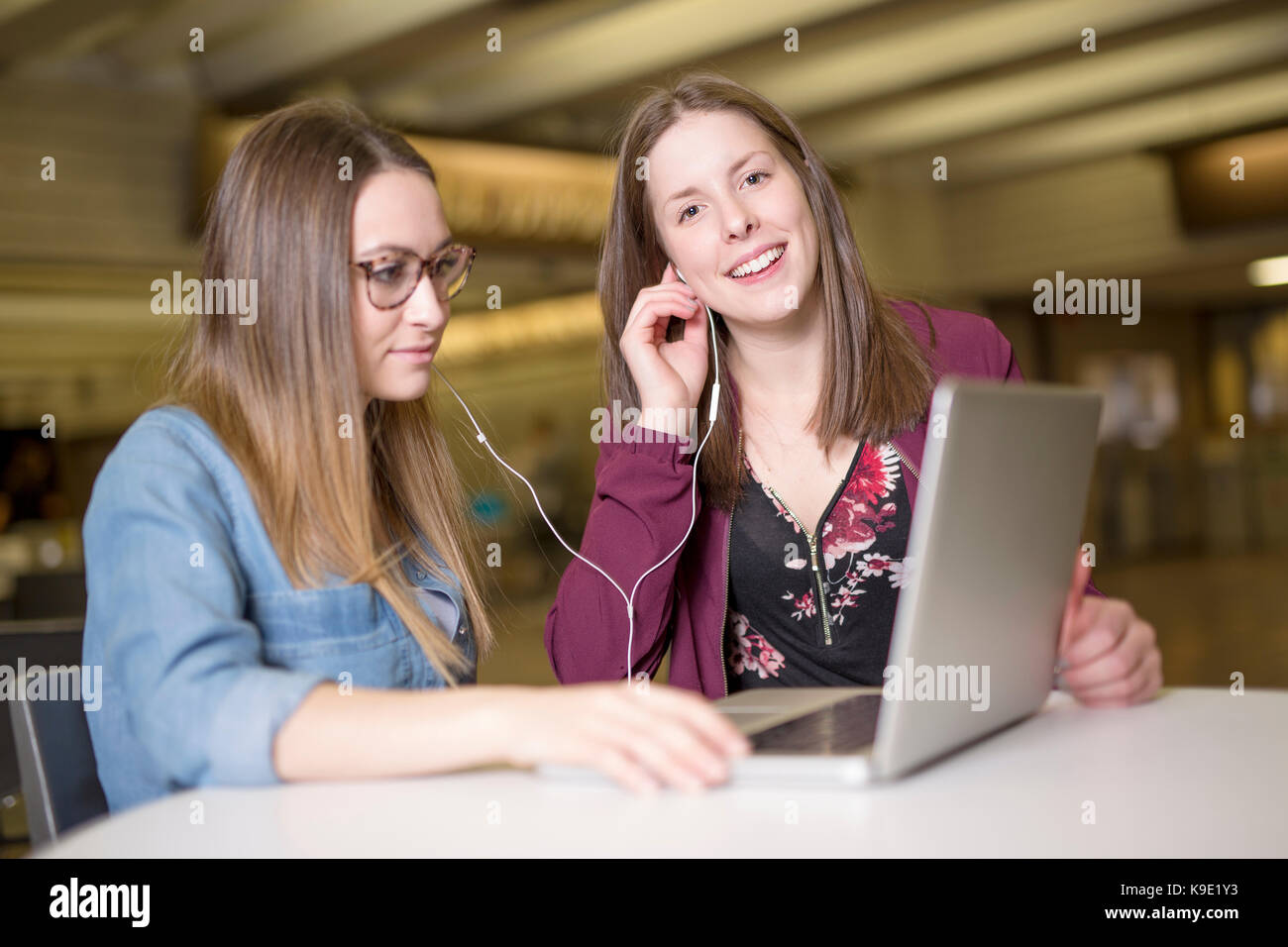 Two pretty female college student studying in the university library ...