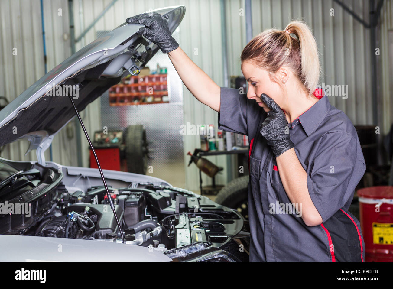 A Mechanic woman working on car in his shop Stock Photo - Alamy