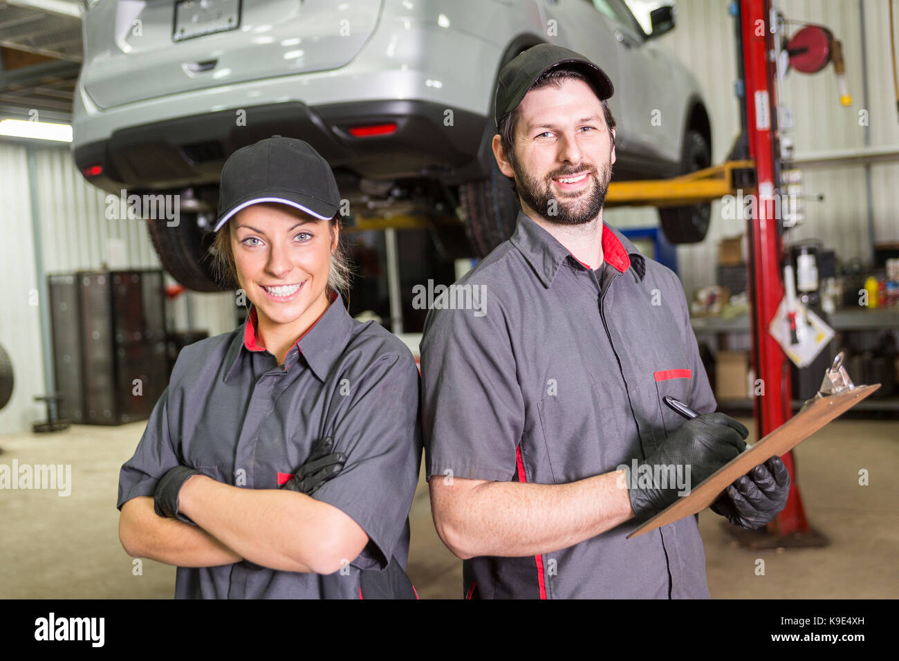 A Mechanic team working on car in his shop Stock Photo - Alamy