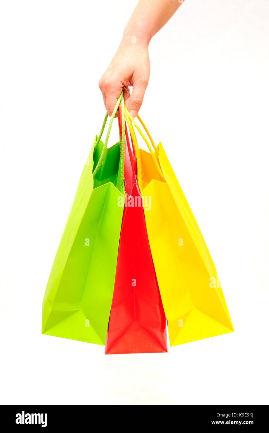 hand holding colorful shopping bags Stock Photo - Alamy
