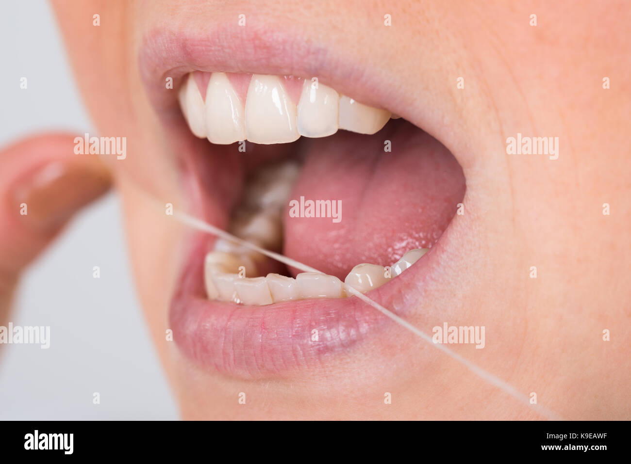Close-up Photo Of A Woman Flossing Teeth Stock Photo - Alamy