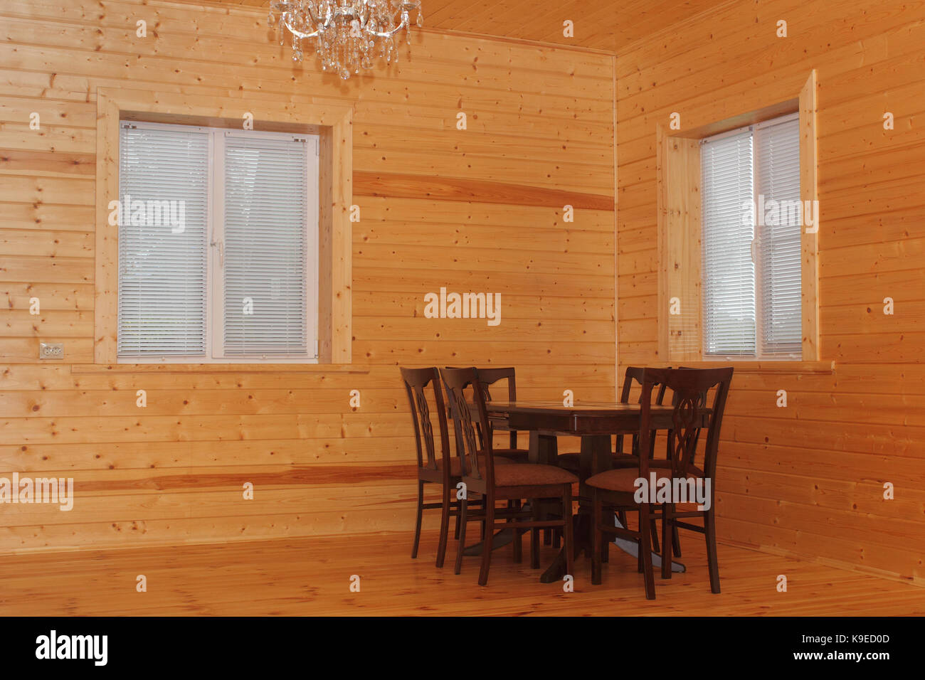 Wooden house interior with table in the corner photo Stock Photo - Alamy