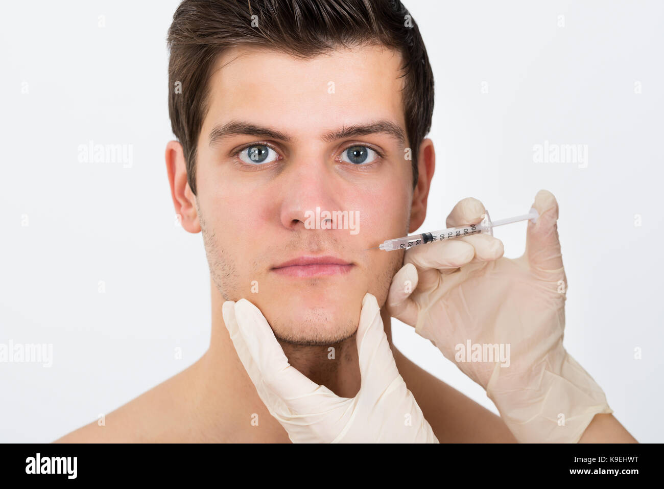 Close-up Of Person Hands Injecting Syringe On Young Man Face Stock ...