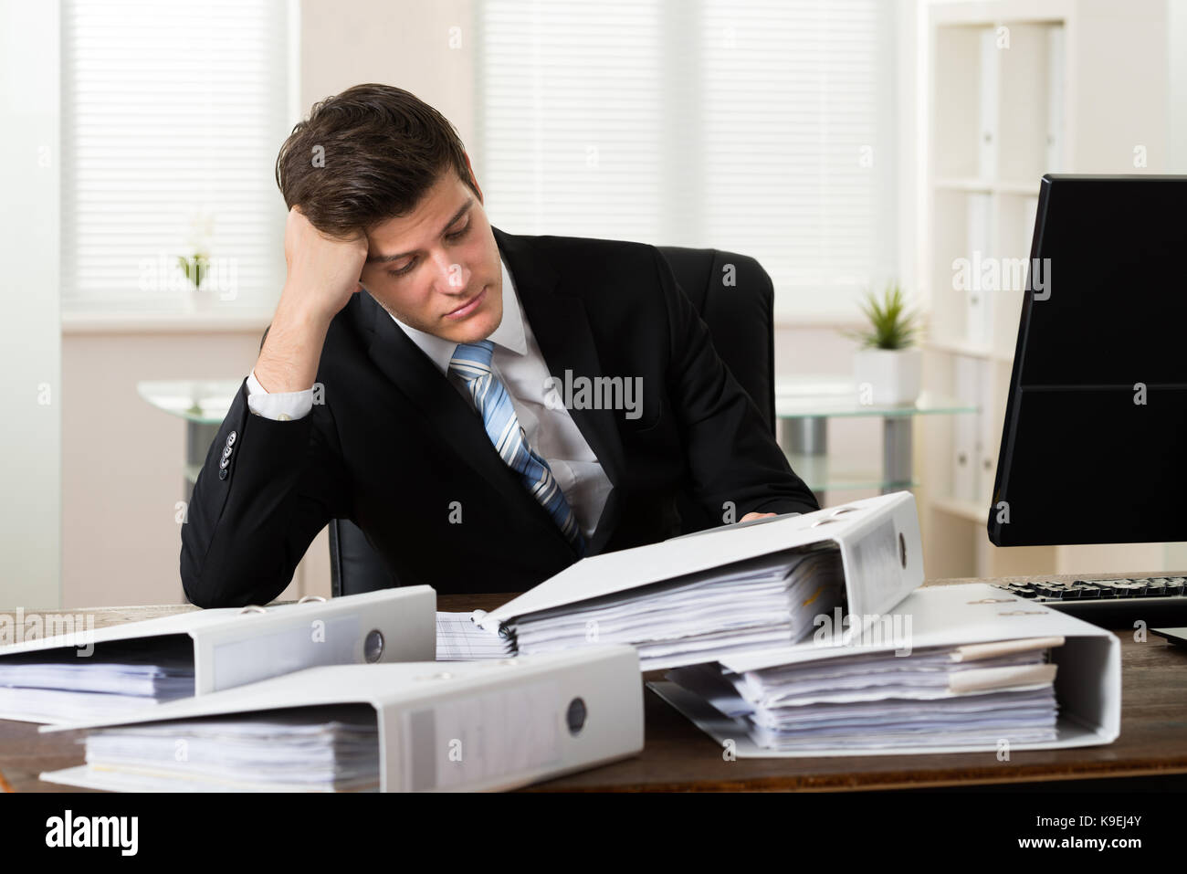 Young Stressed Businessman With Folders Working In Office Stock Photo ...