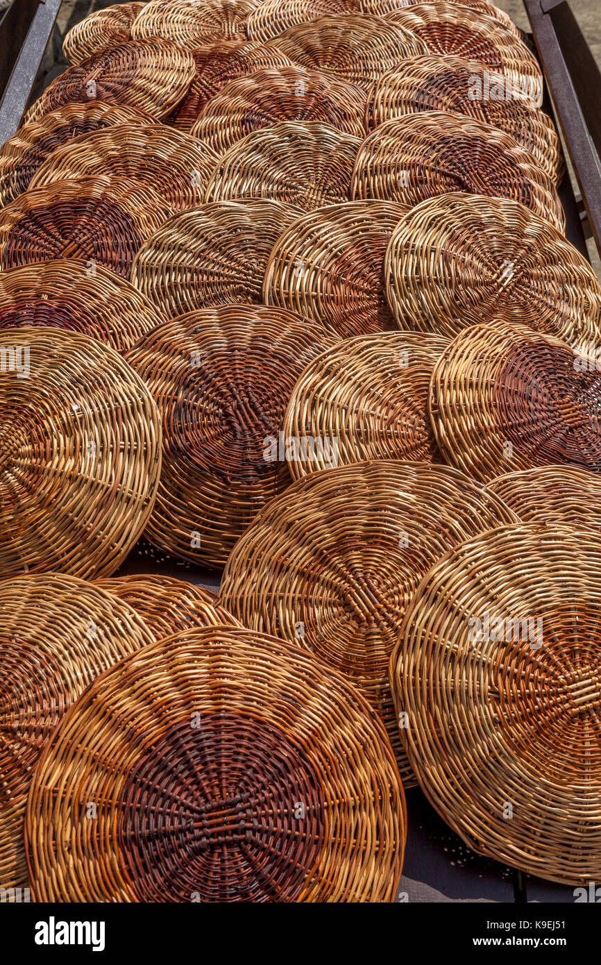 Stacks of round, reed, woven picnic plate holders Stock Photo - Alamy