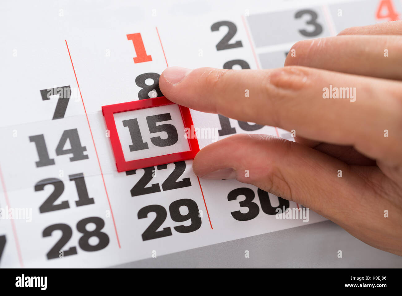 Close-up Of Person Hands Making A Red Mark On Calendar Date Stock Photo ...