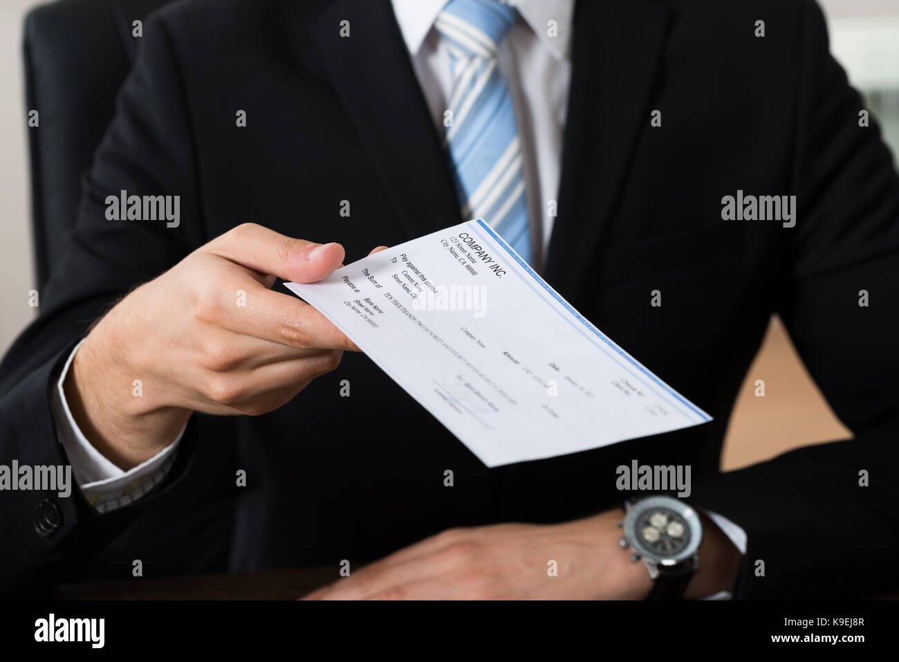 Close-up Of Businessman Hands Giving Cheque In Office Stock Photo - Alamy