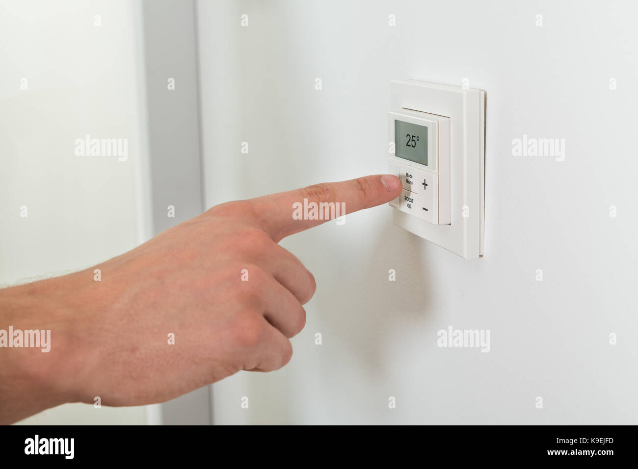 Close-up Of Person Hands Adjusting Room Temperature On A Digital ...