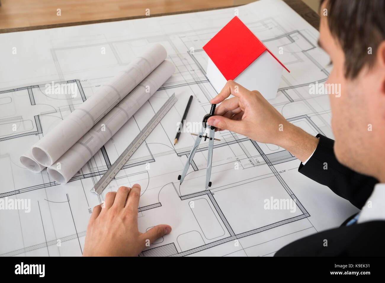 Close-up Of Male Architect Using Compass On Blueprint Paper Stock Photo ...