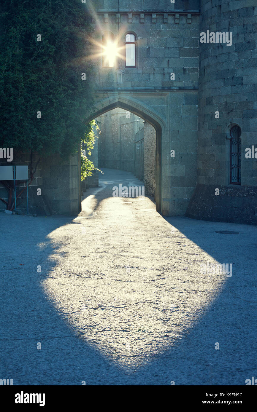 Light falling through an arch and lock window. Mysterious urban scene ...