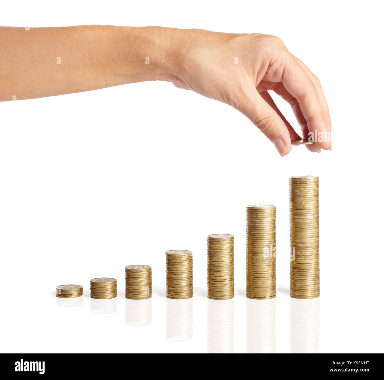 Hand put coins to stack of coins on white background , Saving money ...