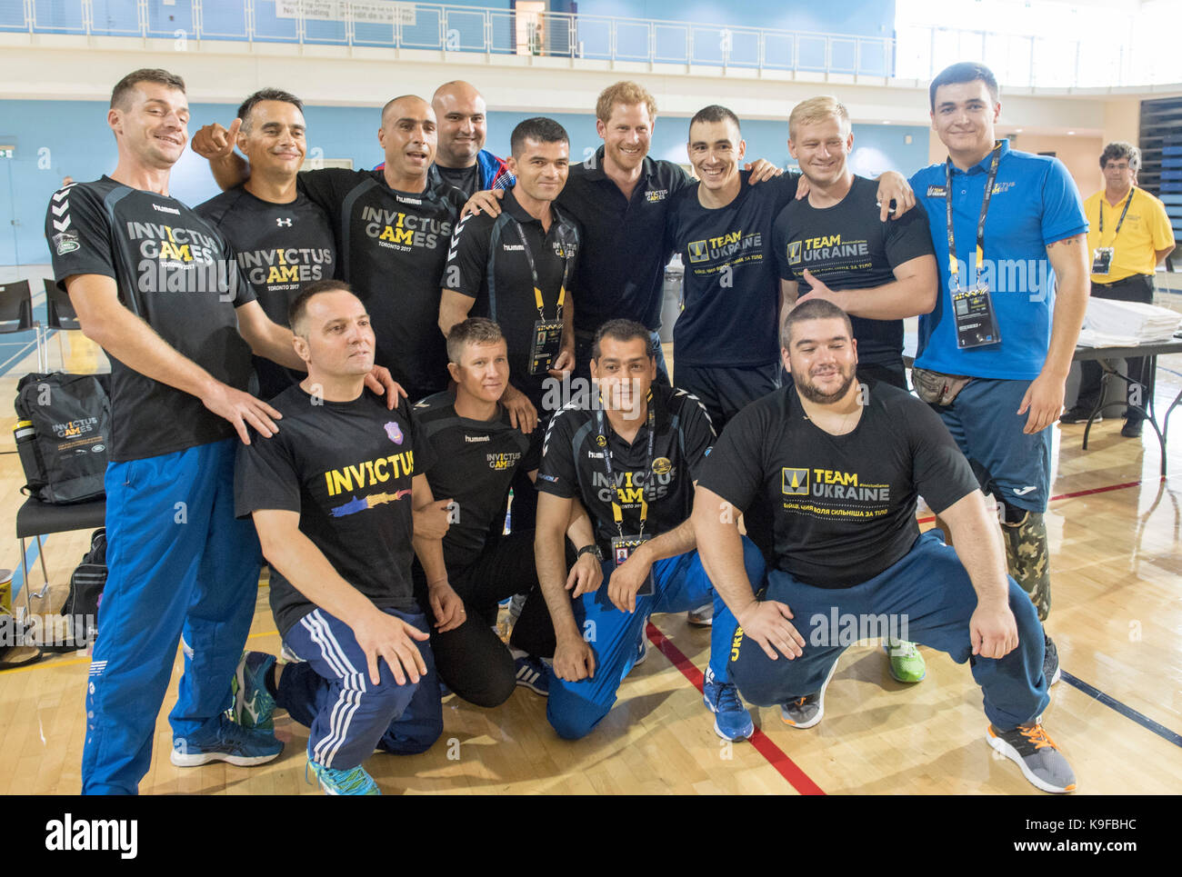 Prince Harry poses for a photo with athletes during a training session ...