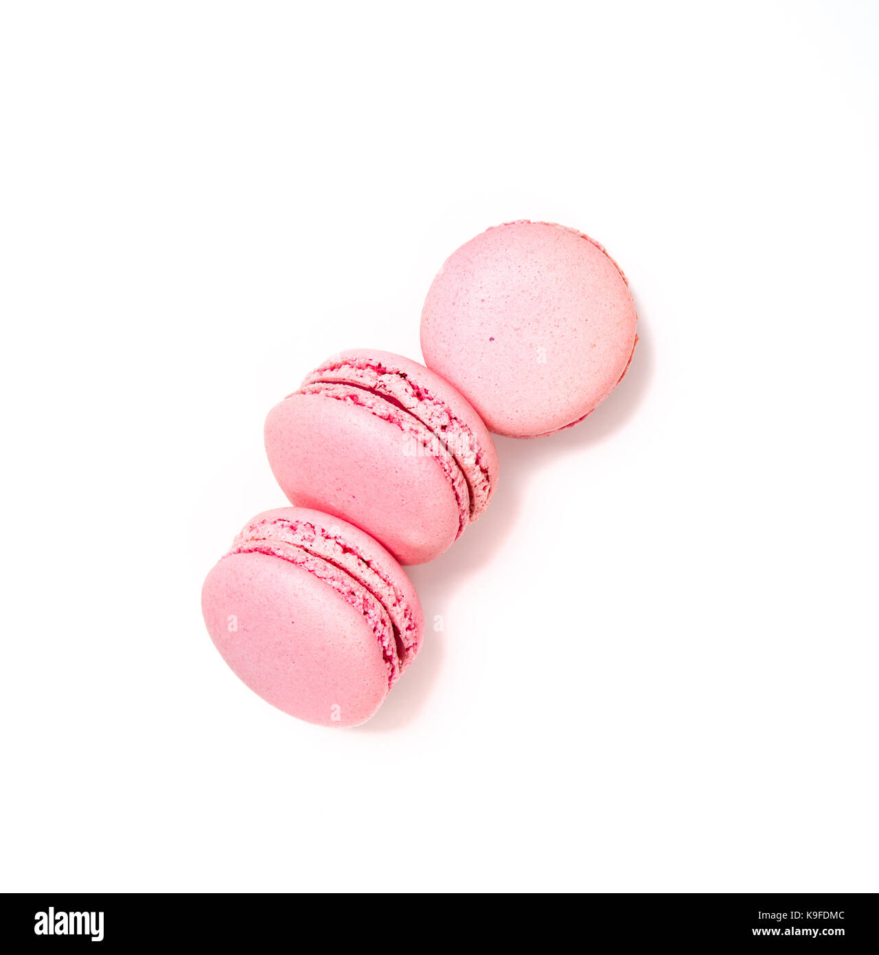 Three pink macaroon cookies isolated on white background, macro shot ...