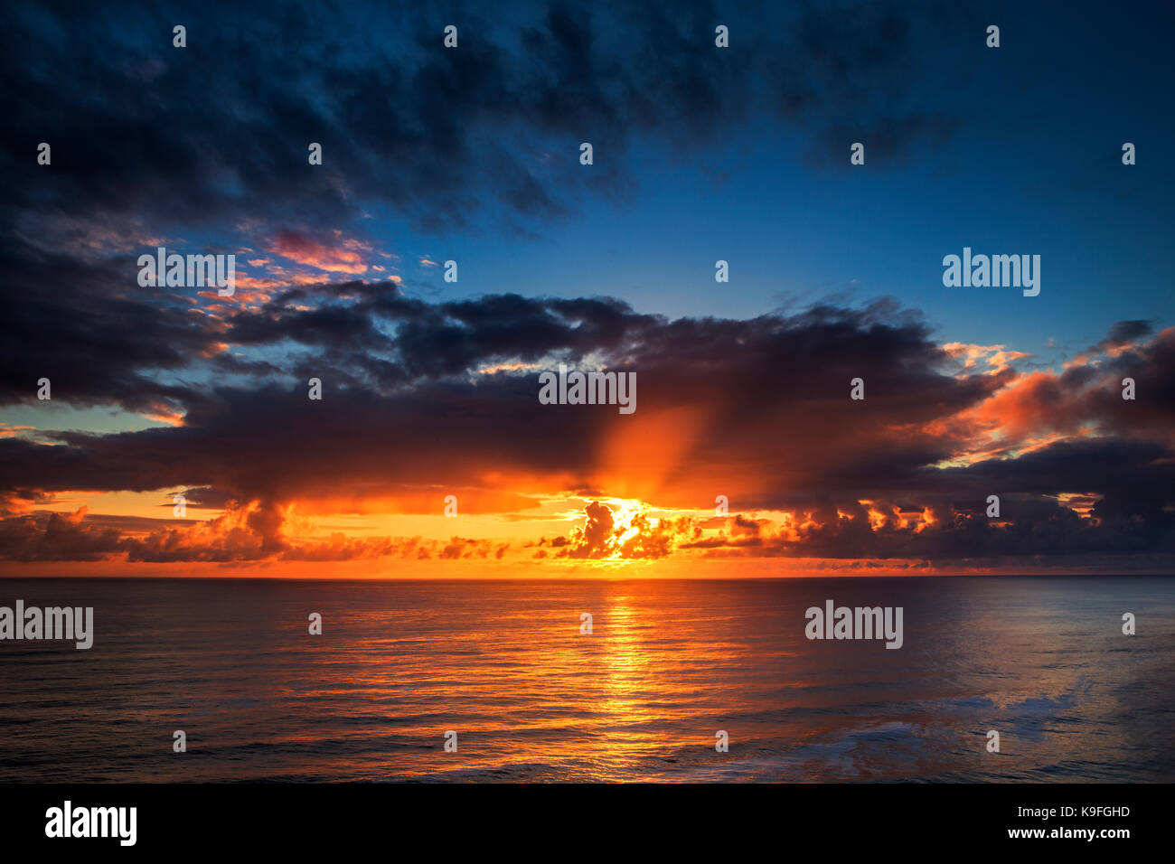Storm clouds clearing at sunset create drama over the Pacific Ocean ...