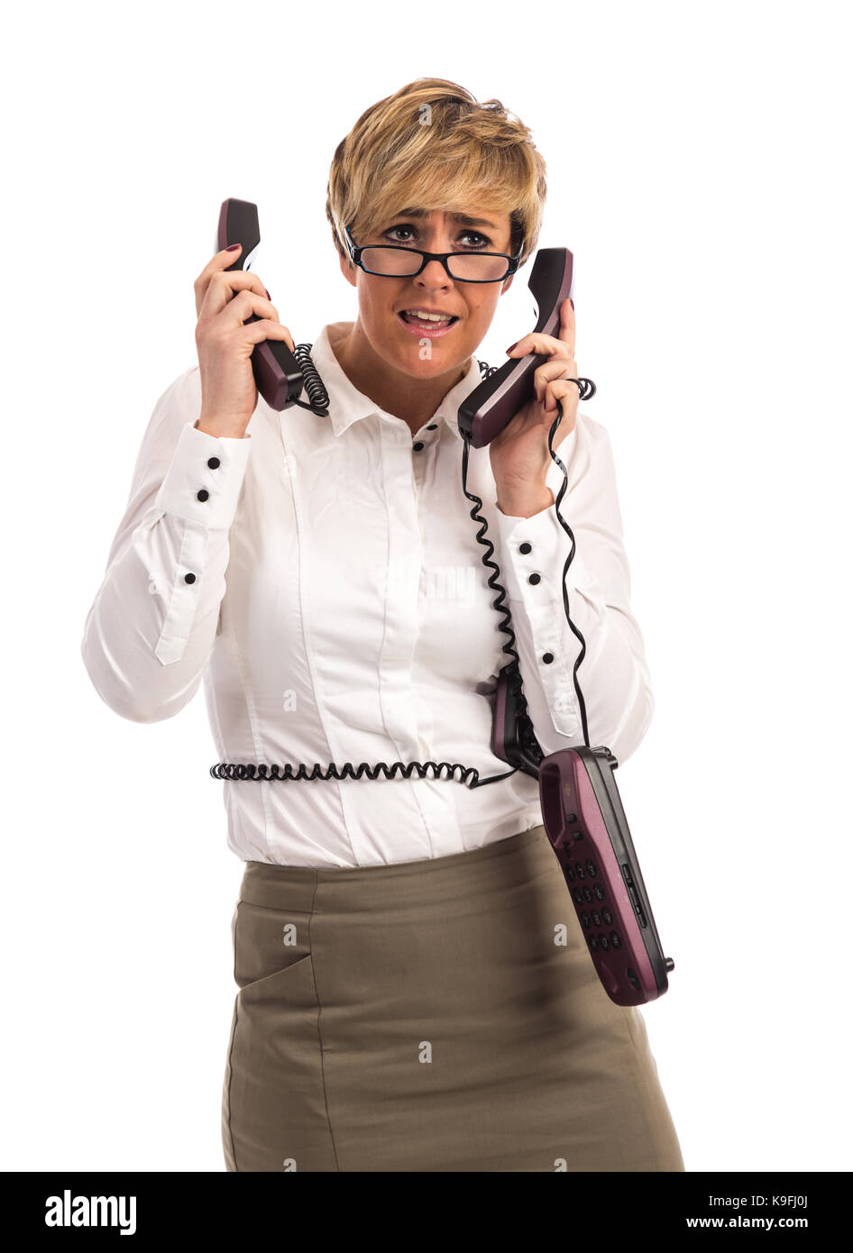An overworked business woman struggles with too many phones Stock Photo ...