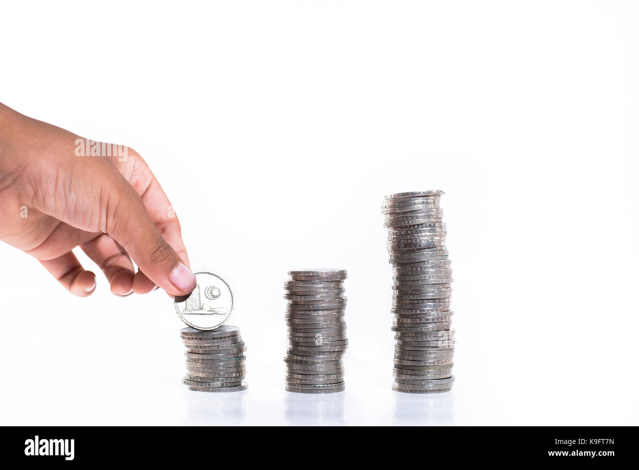 hand stacking coins. Isolated on a white background. Financial concept ...