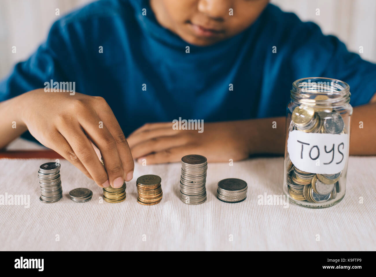 Boy Counting Coins High Resolution Stock Photography and Images - Alamy