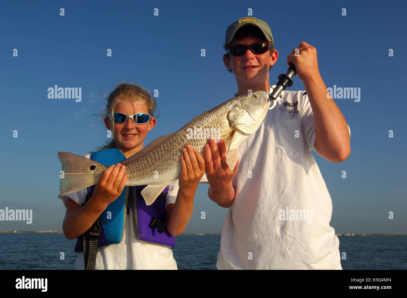 Young boy red drum redfish hi-res stock photography and images - Alamy