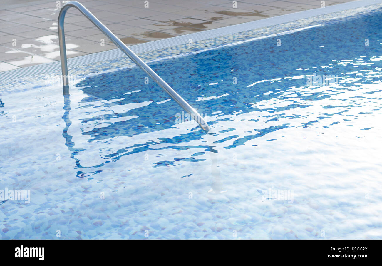 Blue swimming pool on hot sunny day on summer vacation Stock Photo - Alamy