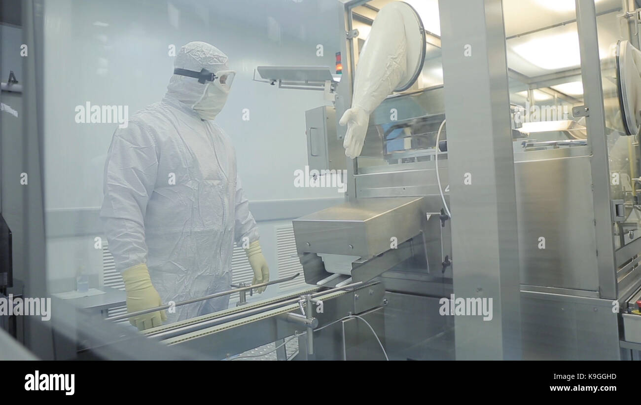 Pharmaceutical industry. Male factory worker inspecting quality of ...