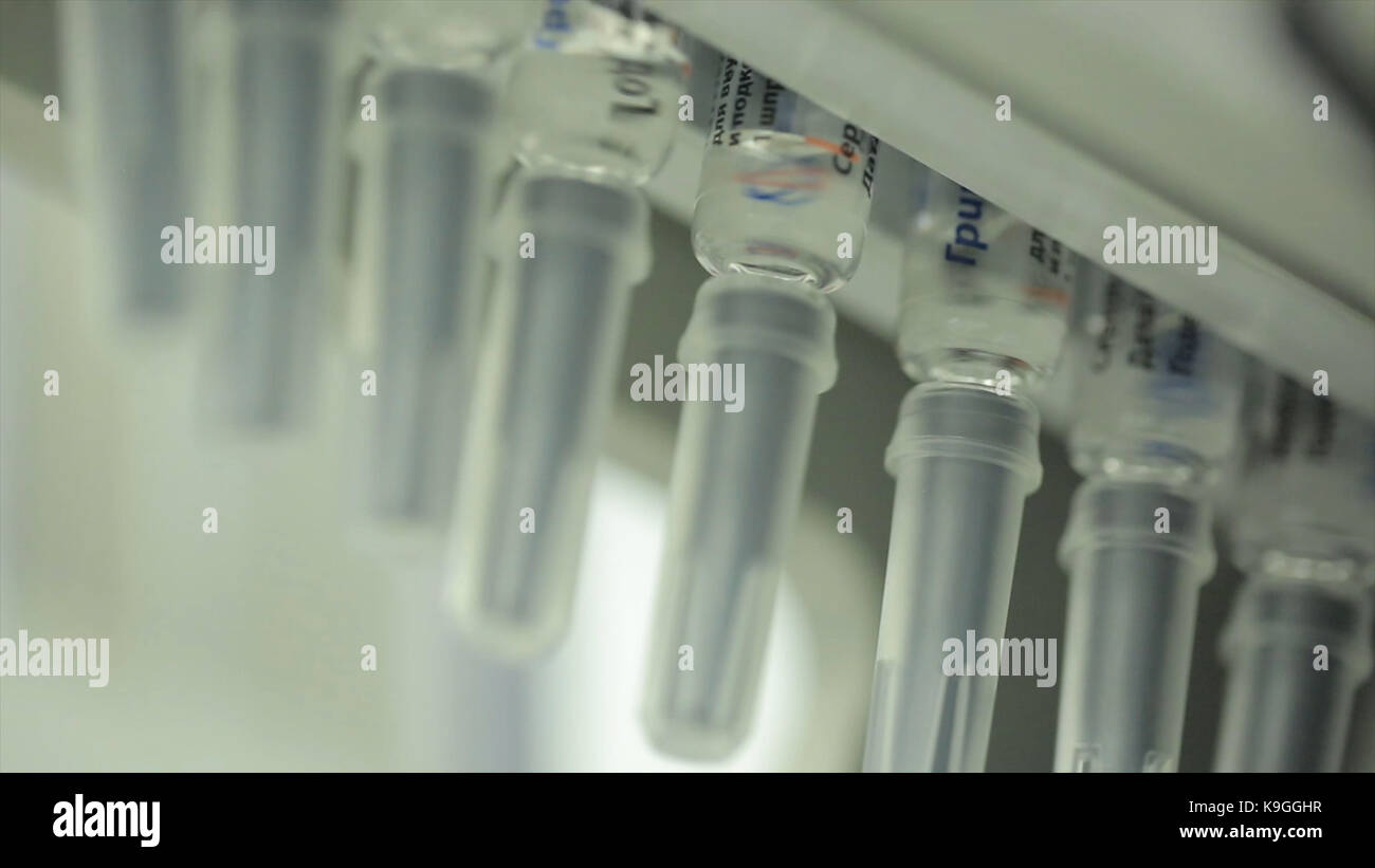 Pharmaceutics. Pharmaceutical worker operates tablet blister packaging ...