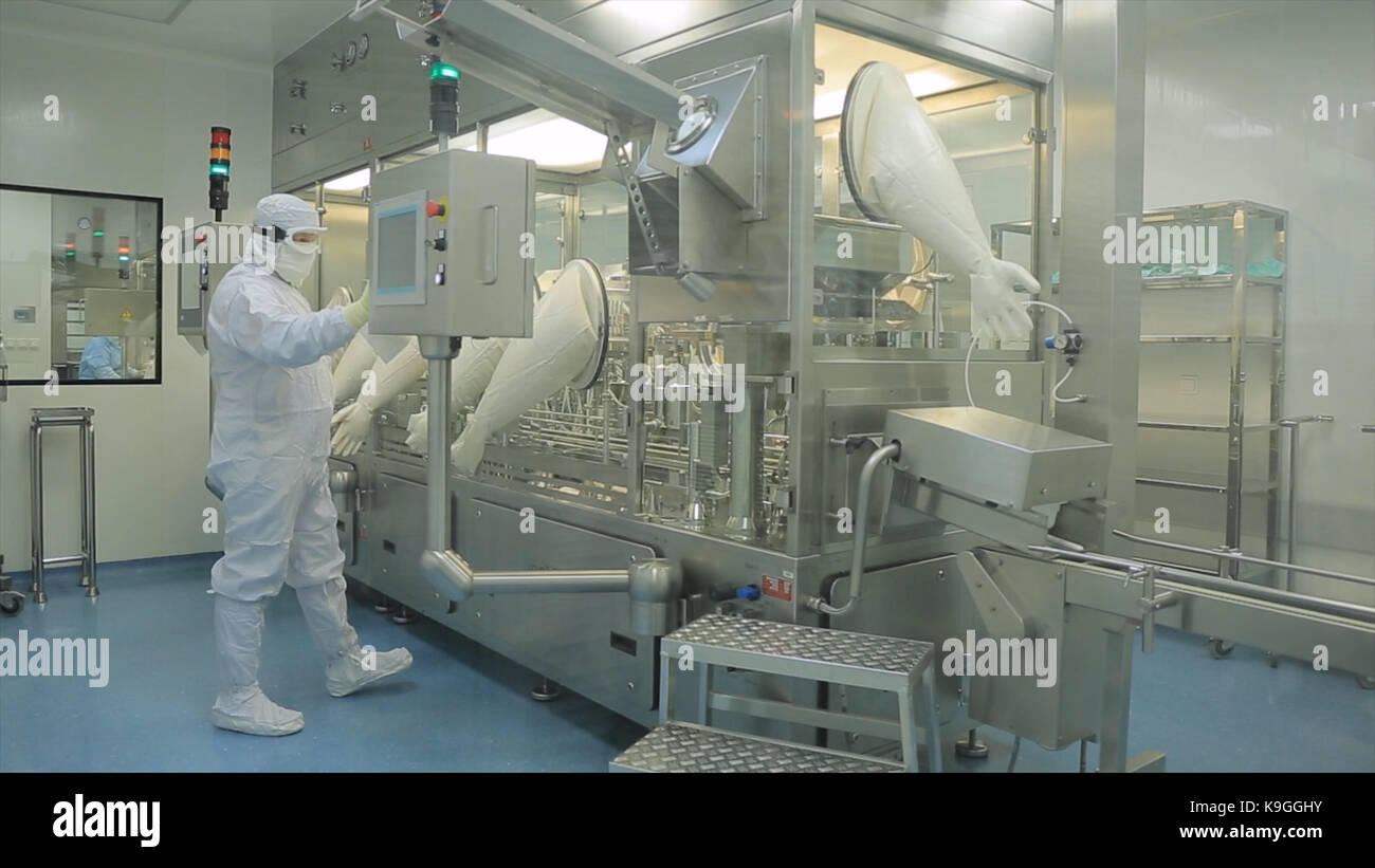 Pharmaceutical industry. Male factory worker inspecting quality of ...