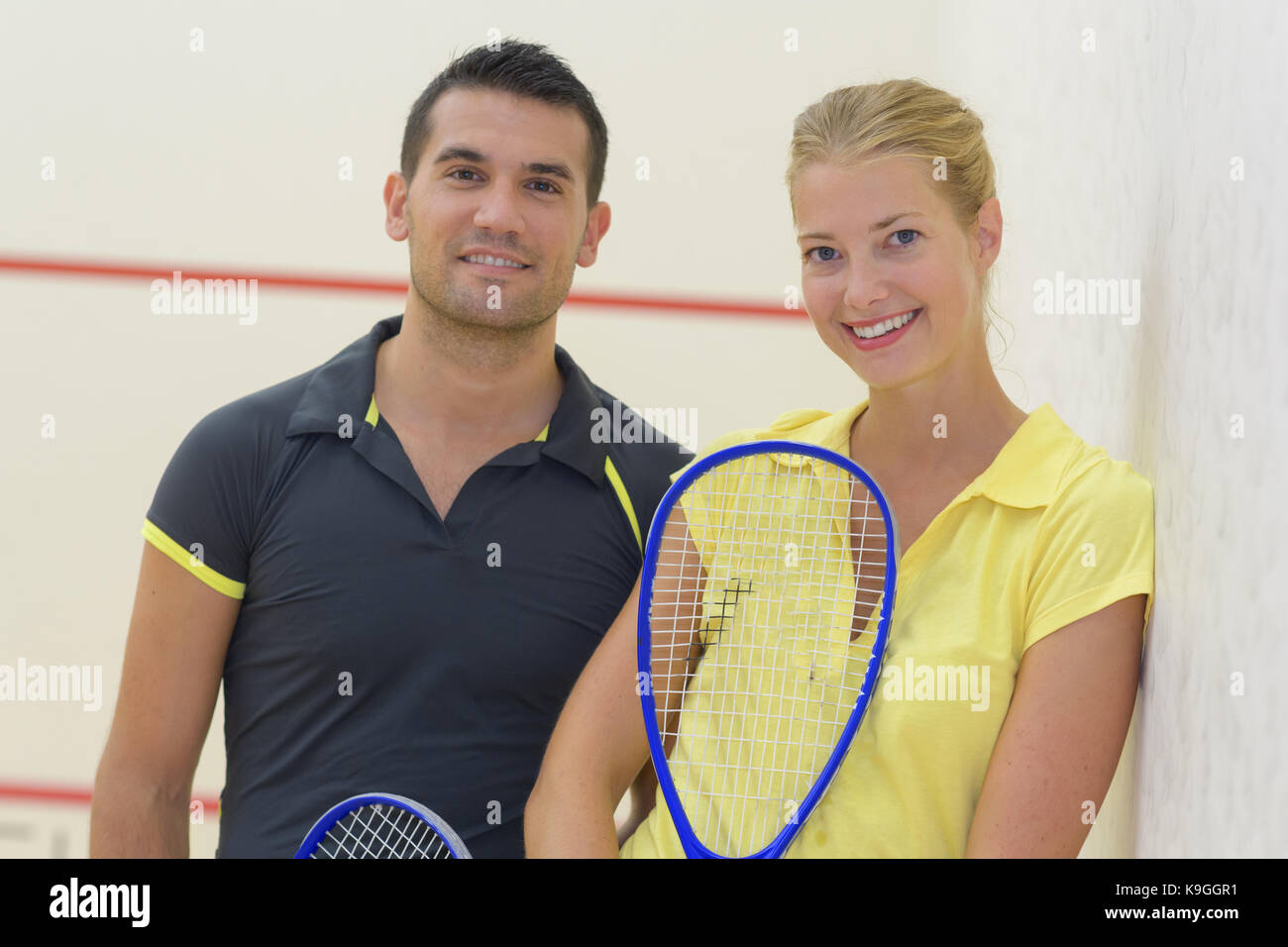 squash player couple posing Stock Photo - Alamy