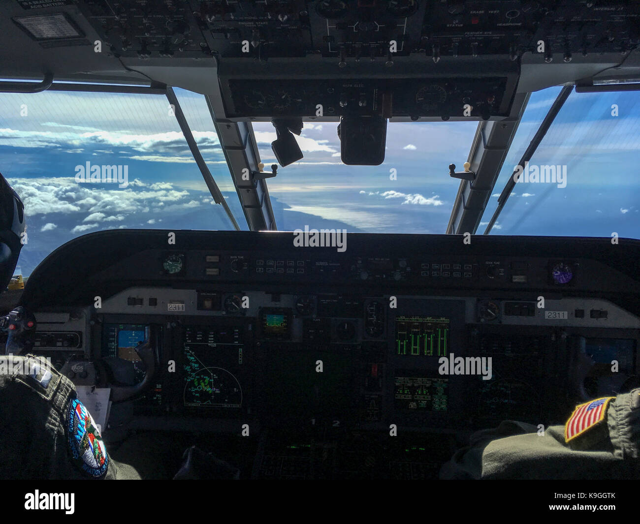 Pilots aboard an HC-144 Ocean Sentry airplane from Coast Guard Air ...