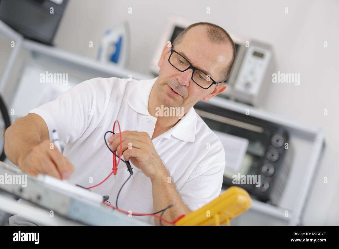 Male tech repairs electronic equipment hi-res stock photography and ...