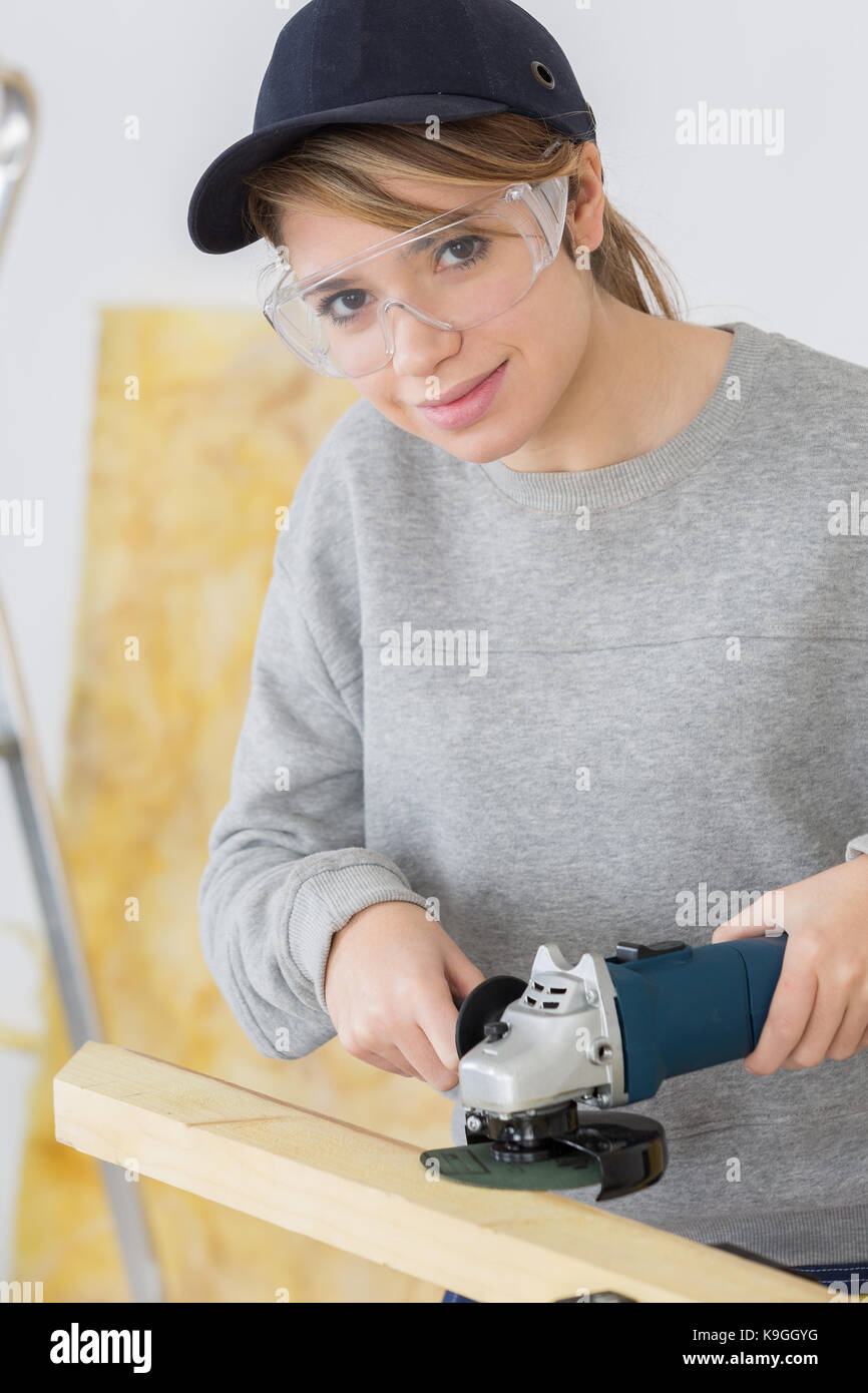 female carpenter using electric sander for wood Stock Photo - Alamy