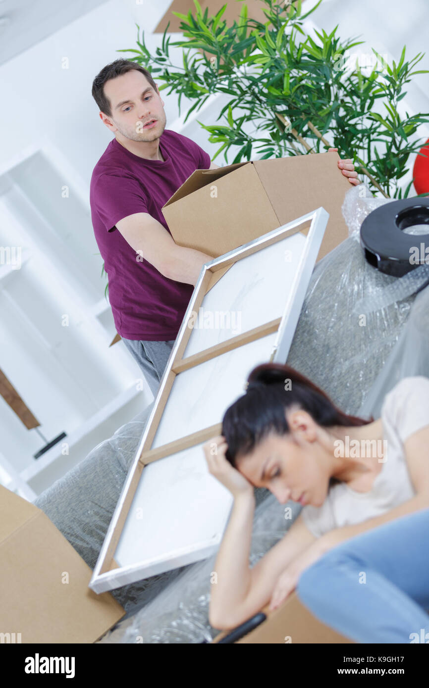 picture of young pair tired of packing their things Stock Photo - Alamy