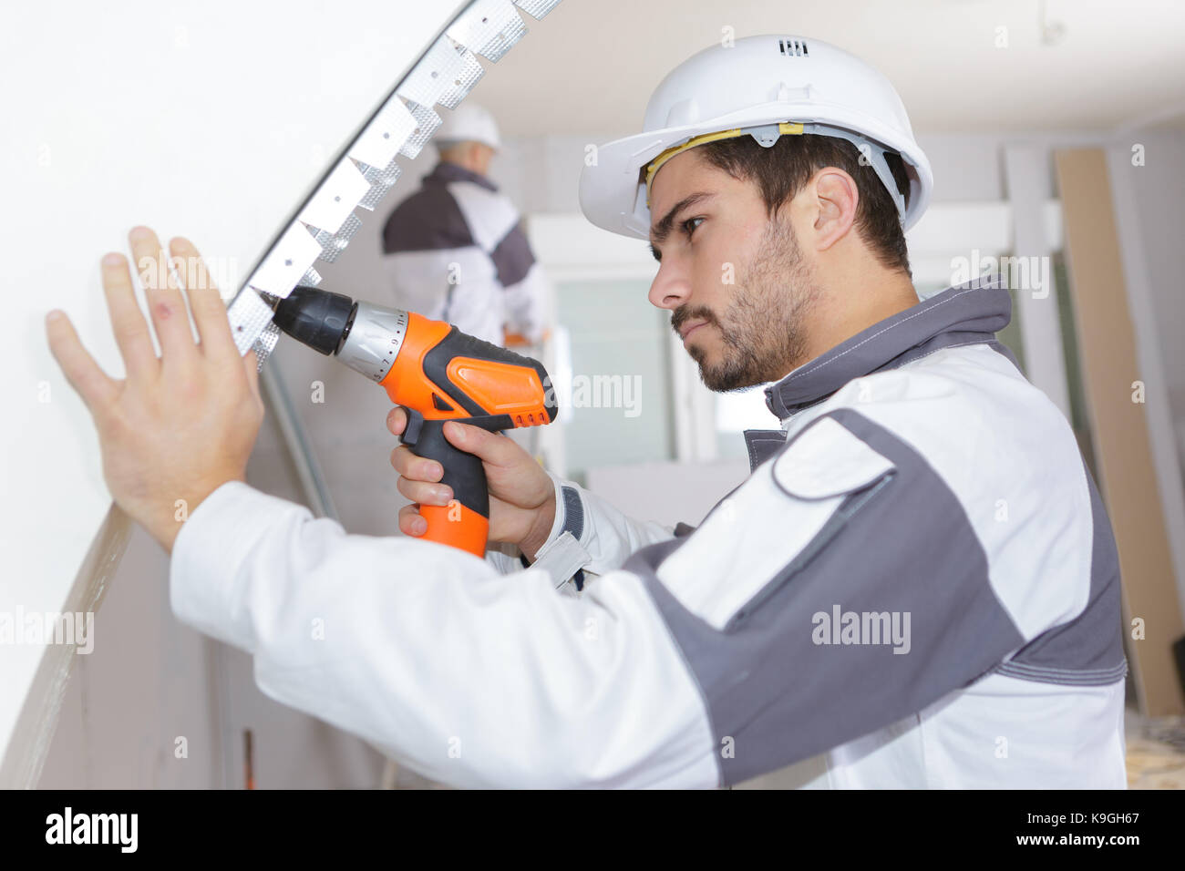 man drilling on the wall Stock Photo - Alamy