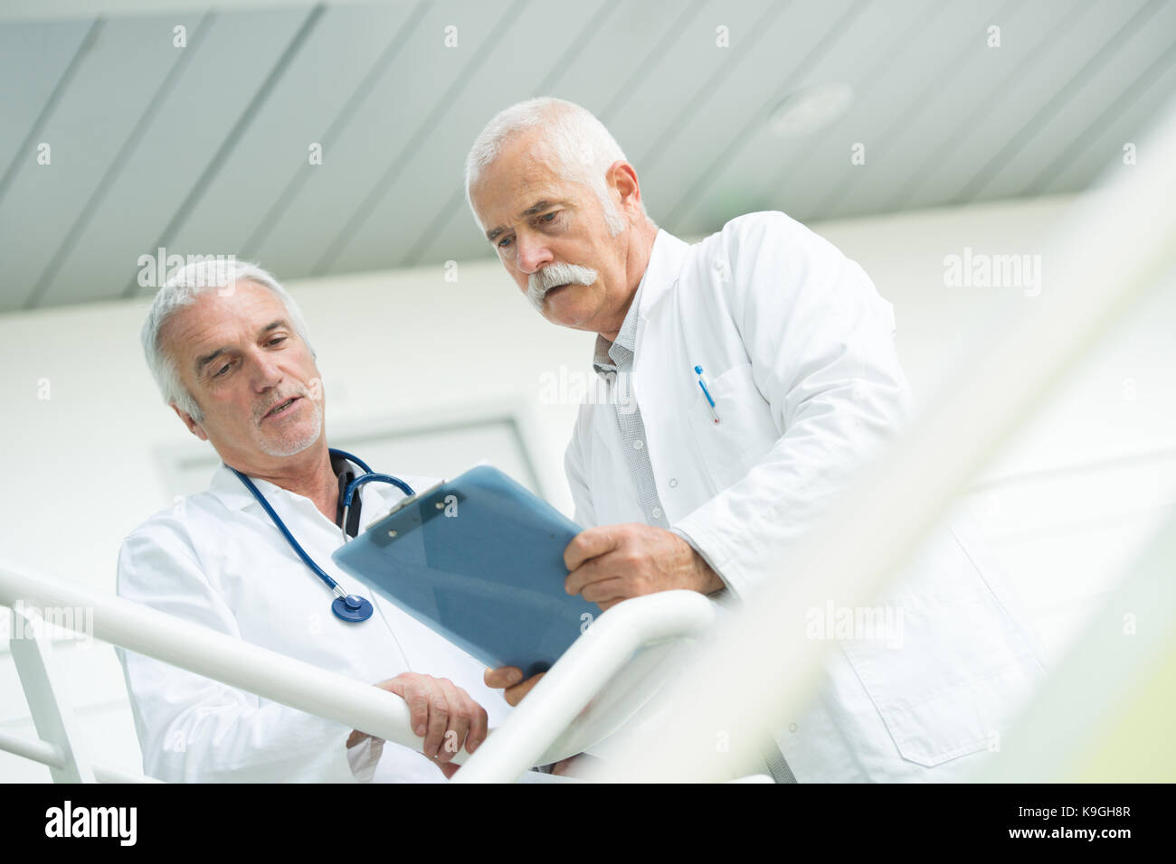 two senior doctors at hospital with clipboard Stock Photo - Alamy
