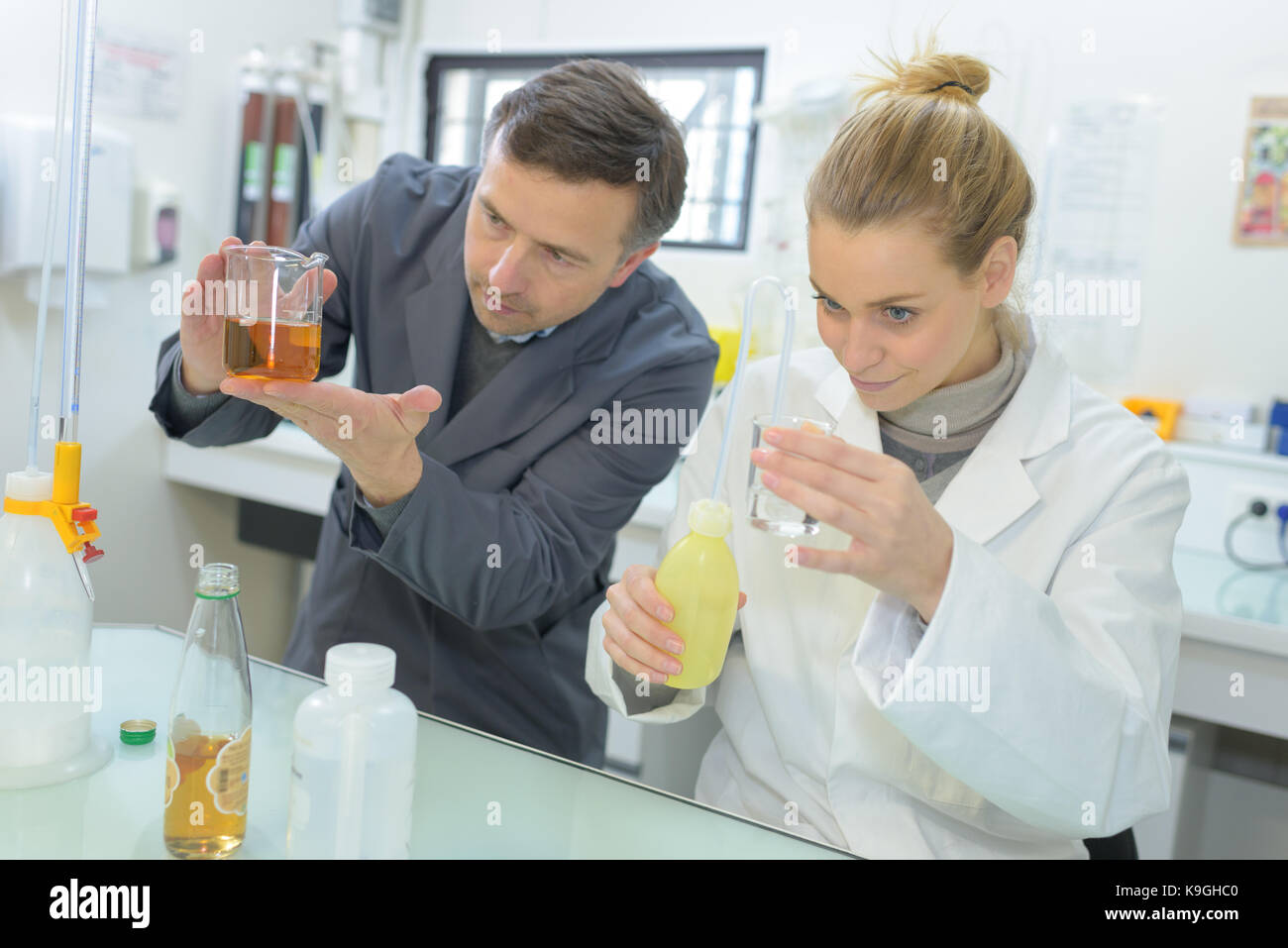 two scientists making experiments with different liquids Stock Photo ...