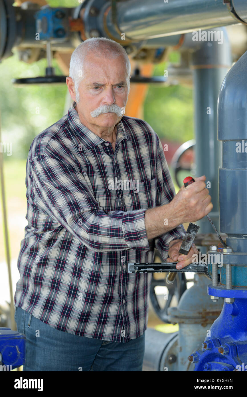 the old mechanic works at the lathe Stock Photo - Alamy